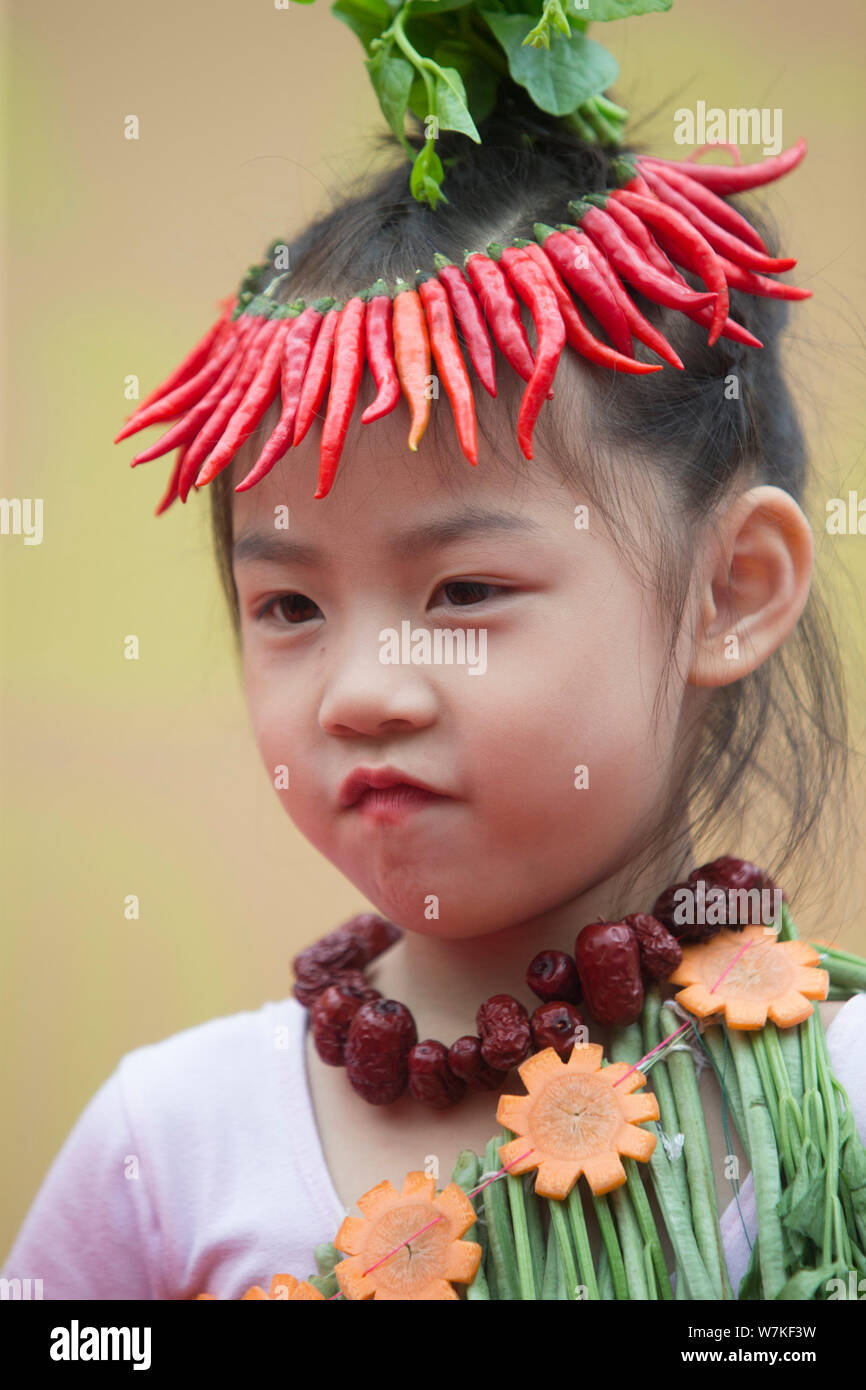 A child displays the ''clothes'' made of vegetables and fruits at a ...