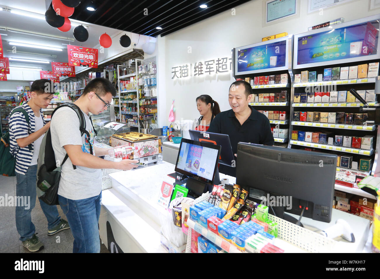 Customers are pictured at the new Tmall convenience store tranformed by ...