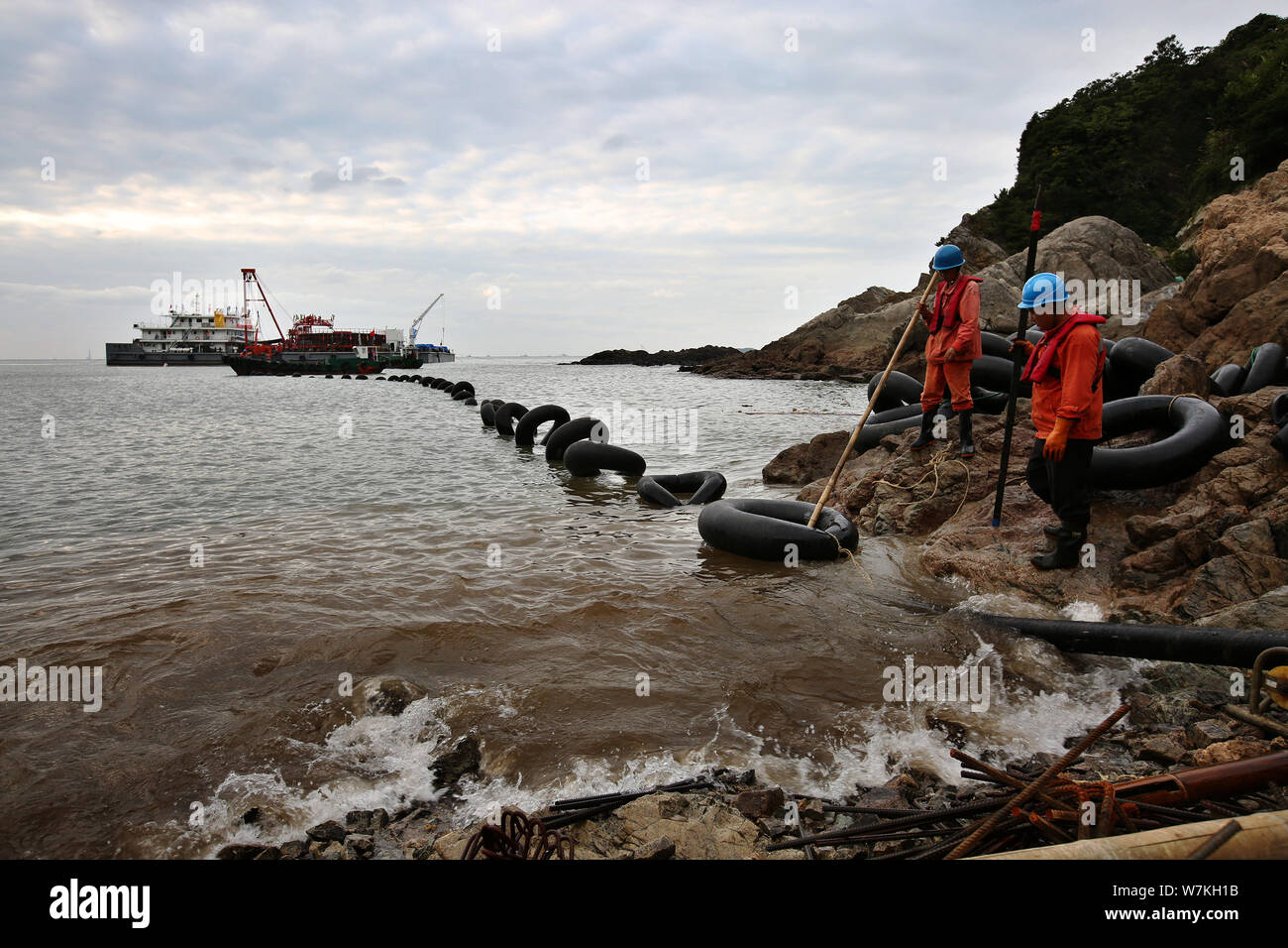 Chinese workers labor at the construction site of the 150MW Putuo No. 6 ...