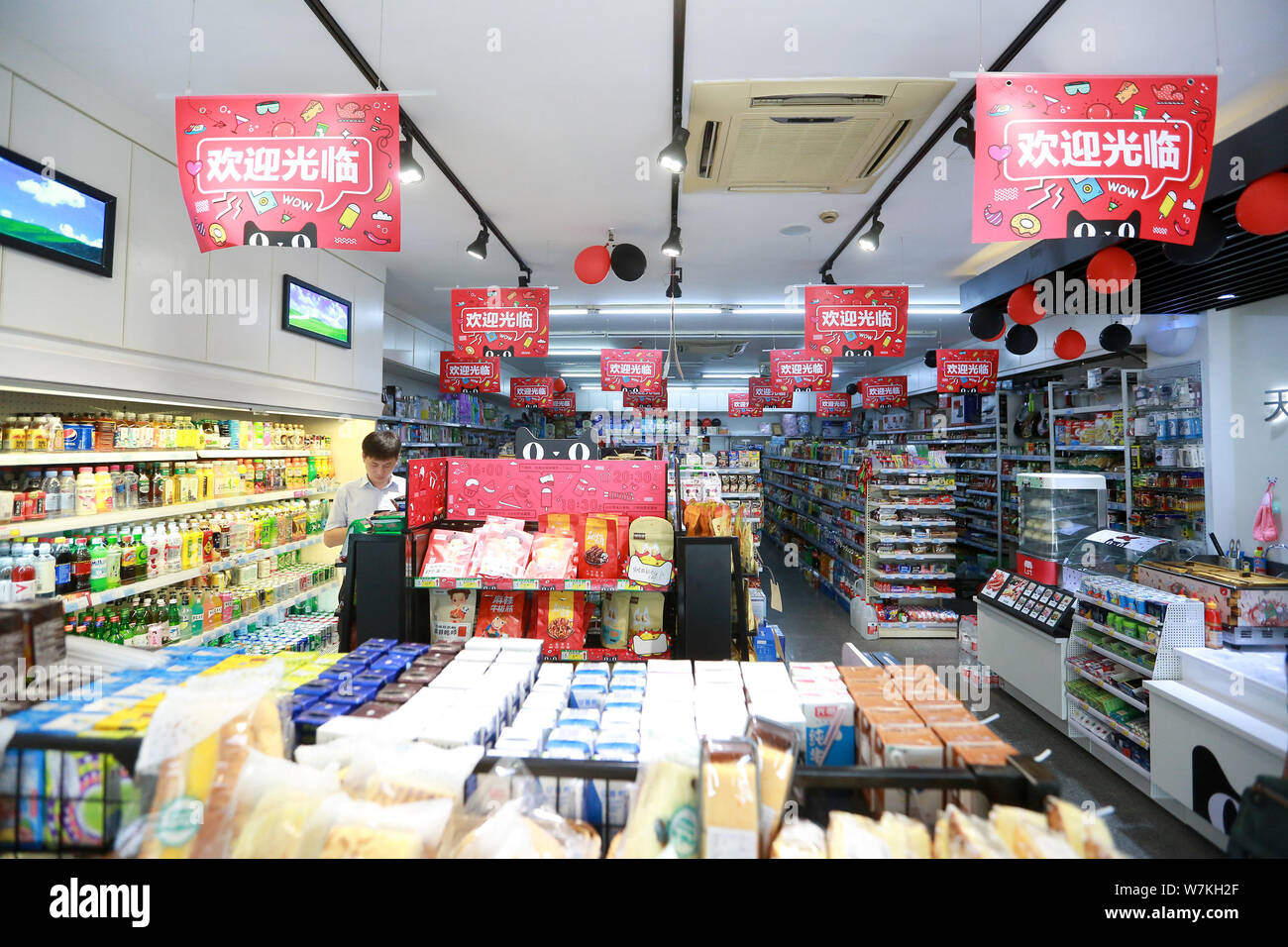 A customer shops at the new Tmall convenience store tranformed by Tmall ...