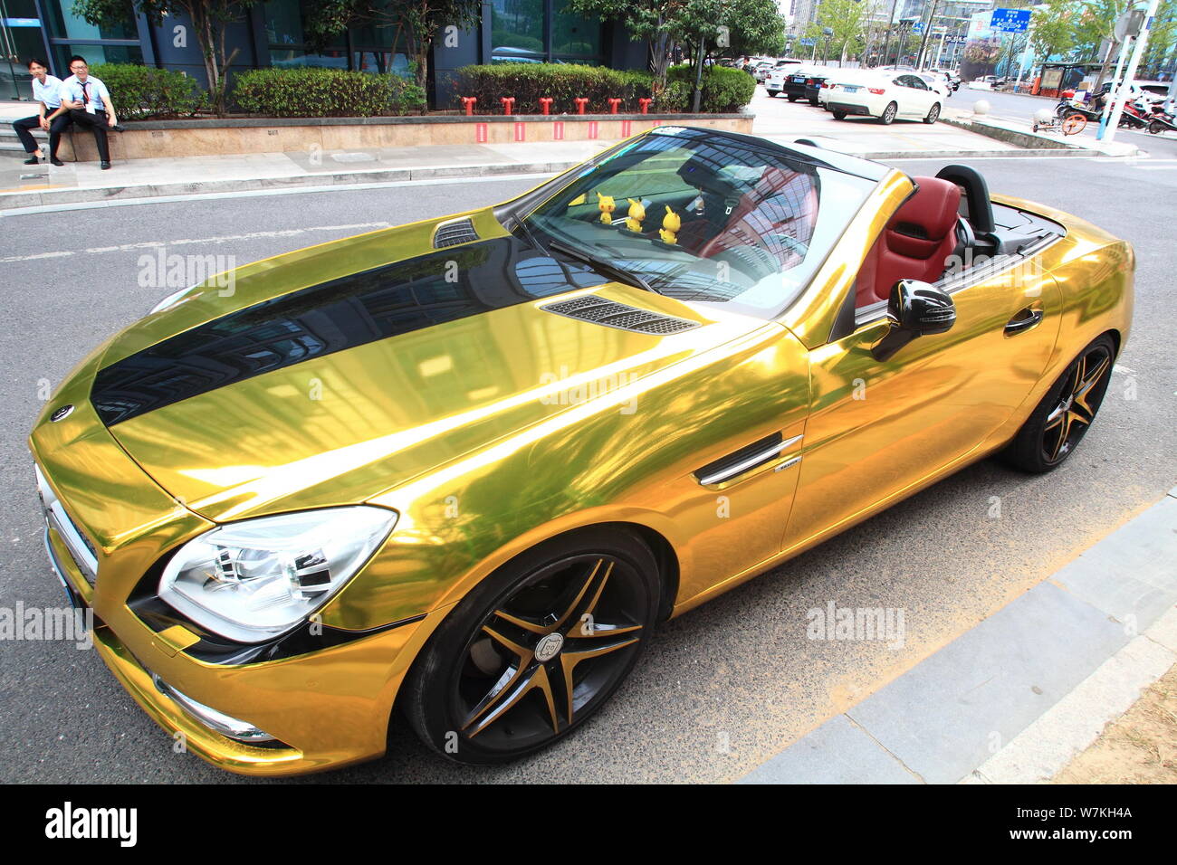 A golden Brabus SLK 350 vehicle is parked in front of a hotel in ...
