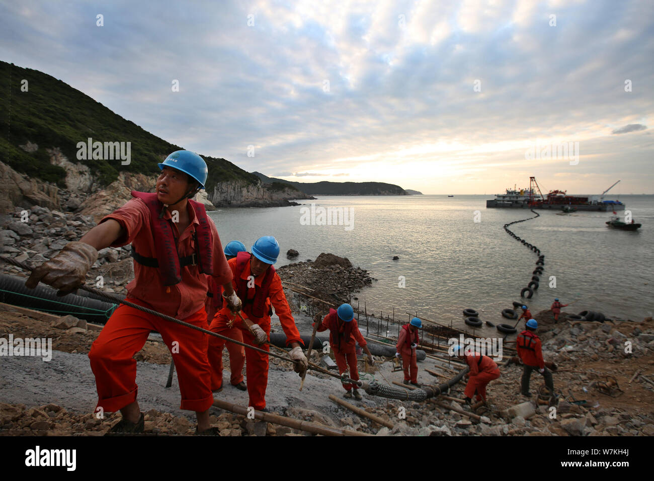 Chinese workers labor at the construction site of the 150MW Putuo No. 6 ...