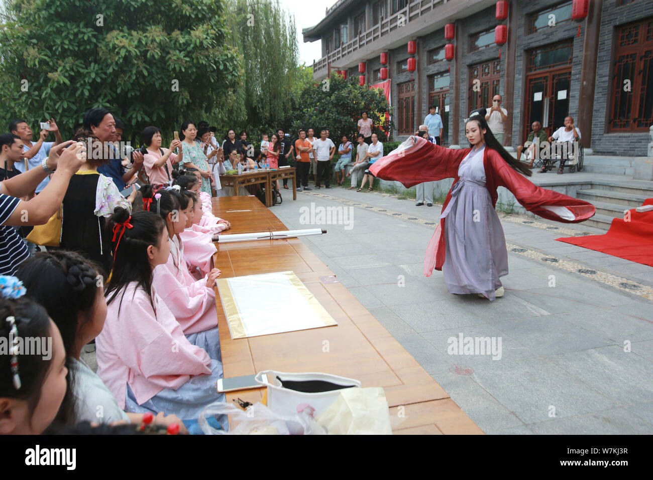 A Chinese woman dressed in traditional costume performs during a ...
