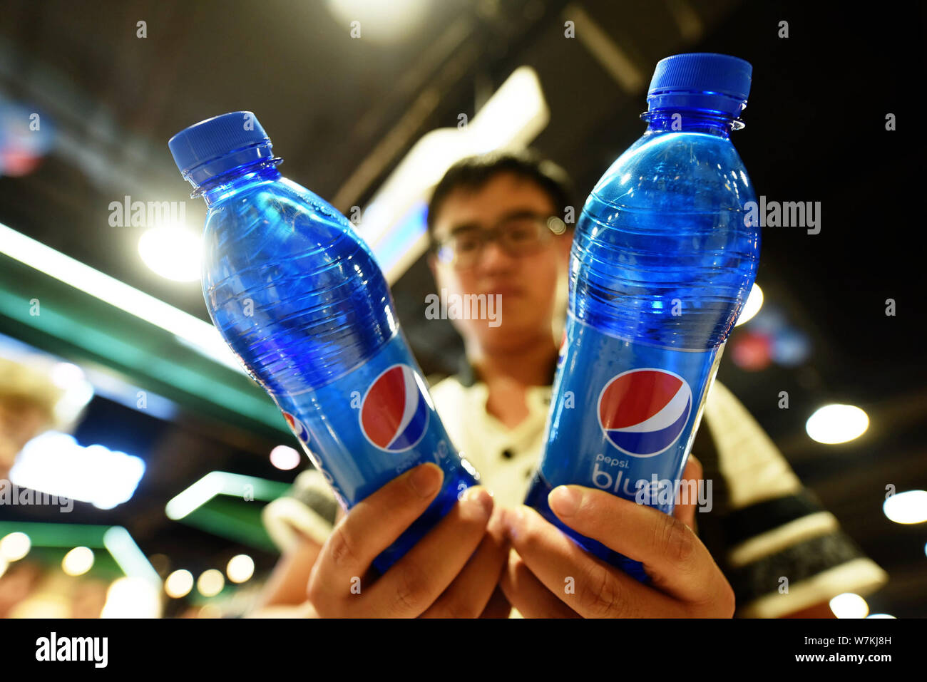 A Chinese customer displays ''Pepsi Blue'' at a supermarket in Hangzhou ...