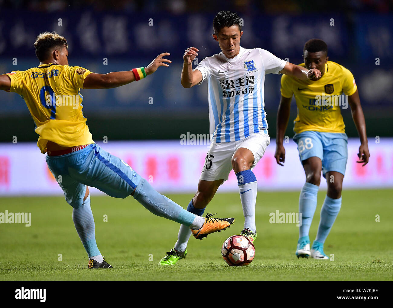 Colombian football player Roger Martinez, left, of Jiangsu Suning kicks ...