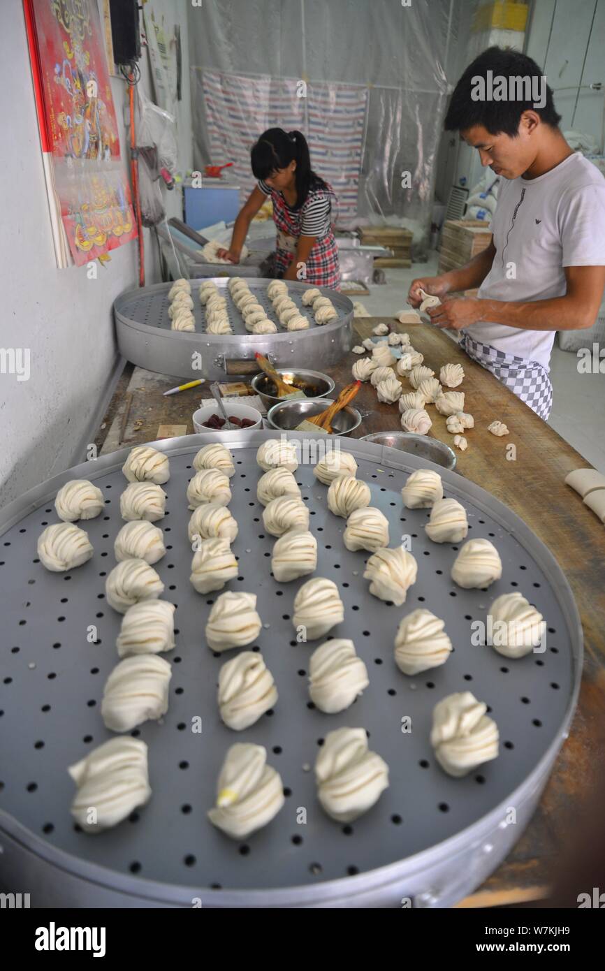 Chinese young couple Wang Wei and Zhang Yin make the paste to be ...