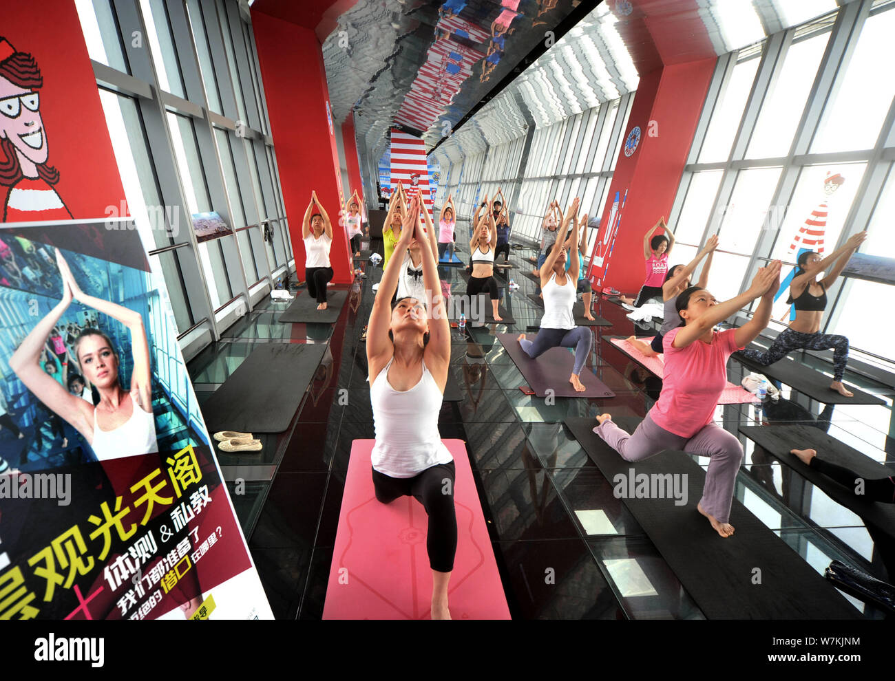 Chinese office ladies practice yoga on the 100th floor of the Shanghai ...