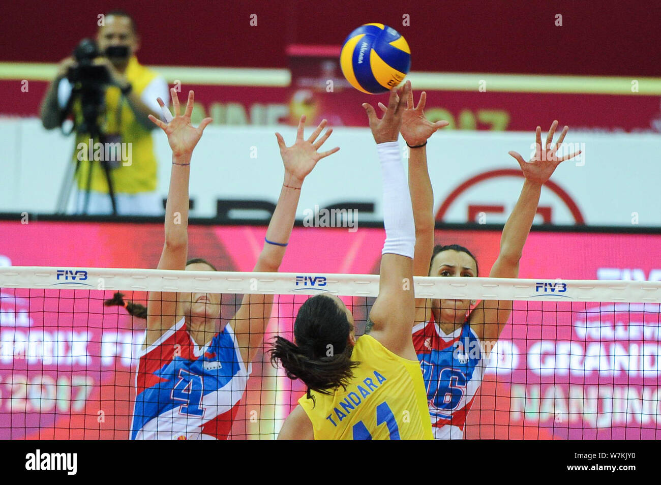 Tandara Caixeta of Brazil spikes against Bojana Zivkovic and Milena ...