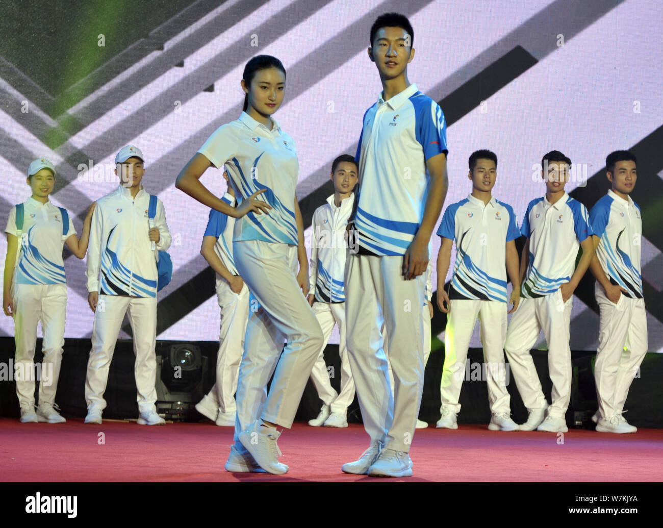 Representatives of Chinese volunteers display volunteer's uniforms for ...