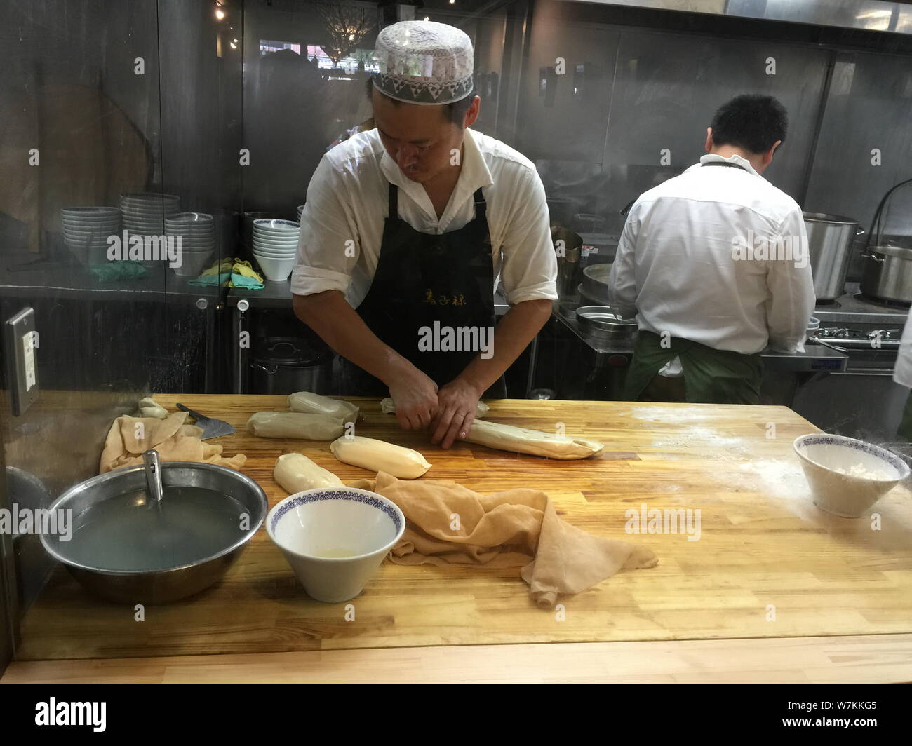 Chefs prepare Lanzhou hand-pulled noodles for customers at a Lanzhou ...