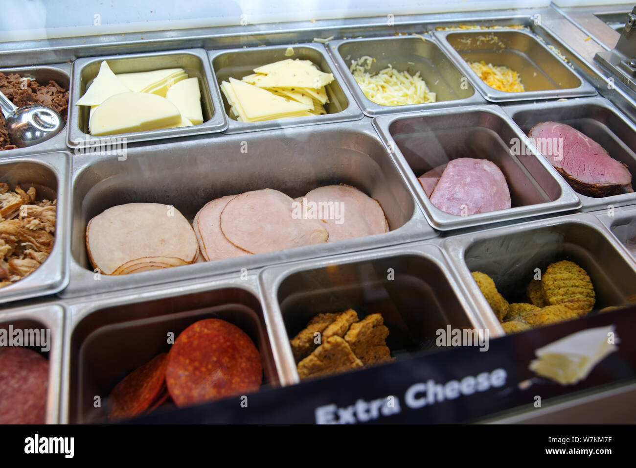 Various types of meats, cold cuts, and cheese at a sub sandwich eatery ...