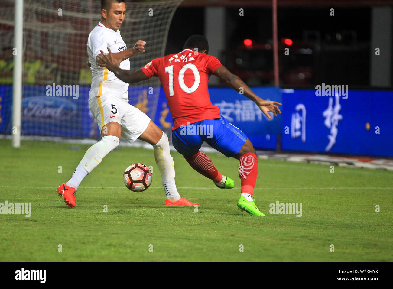 Cameroonian football player Christian Bassogog, right, of Henan Jianye ...