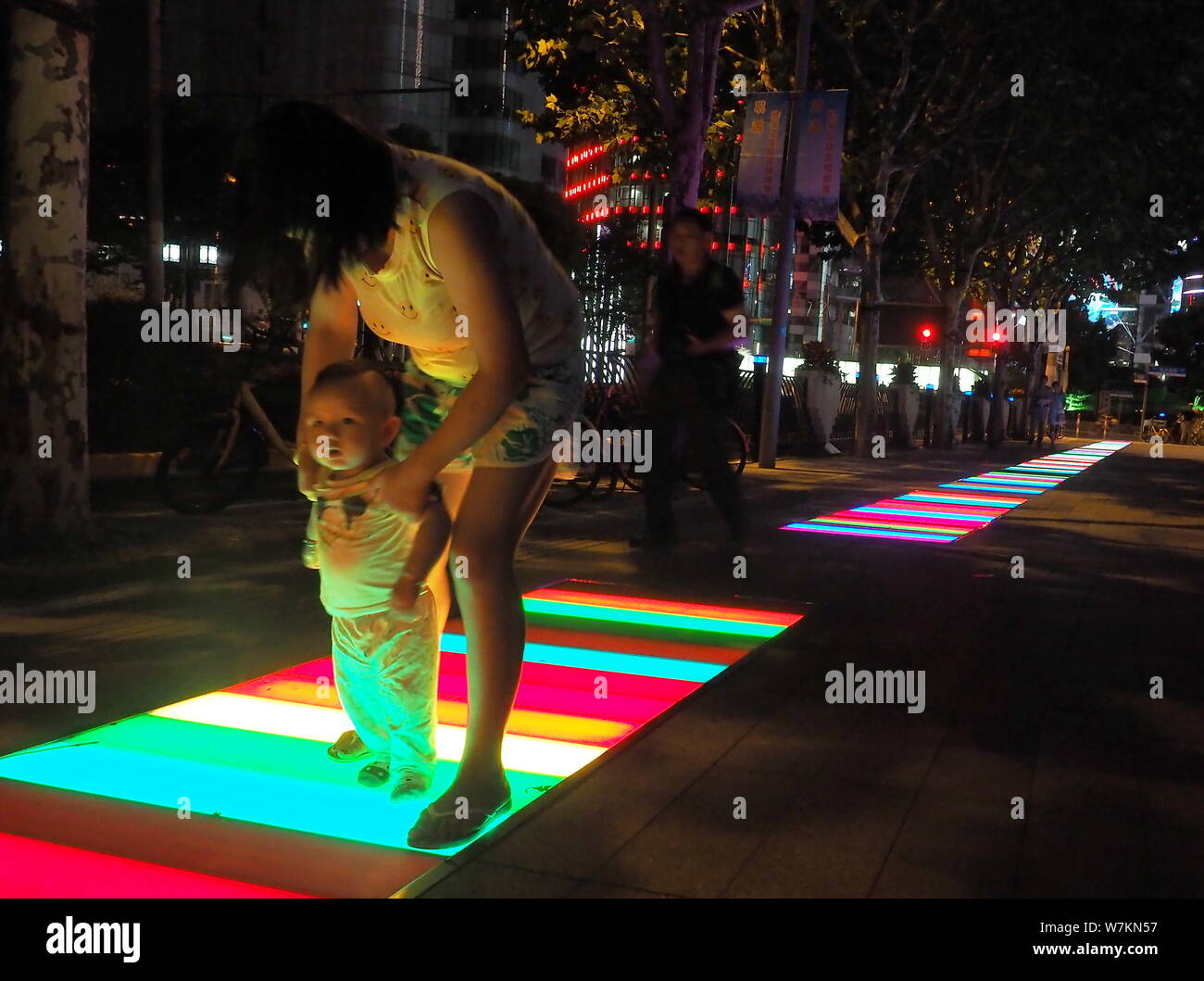 Local residents walk on the promenade featuring colourful LED lights in ...