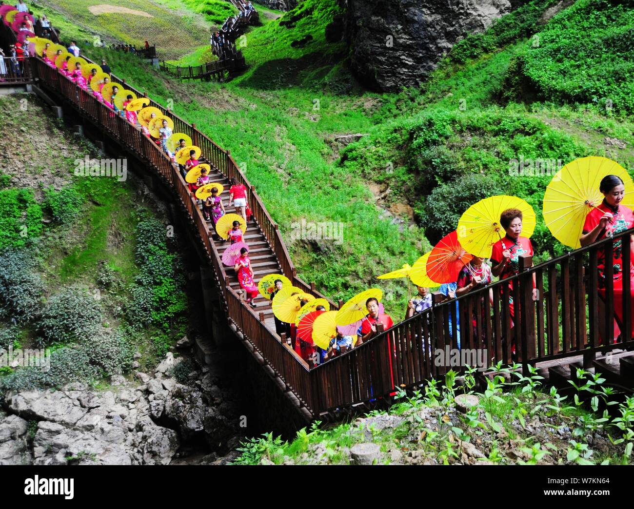 Chinese women present cheongsam, also known as qipao in Chinese, during ...