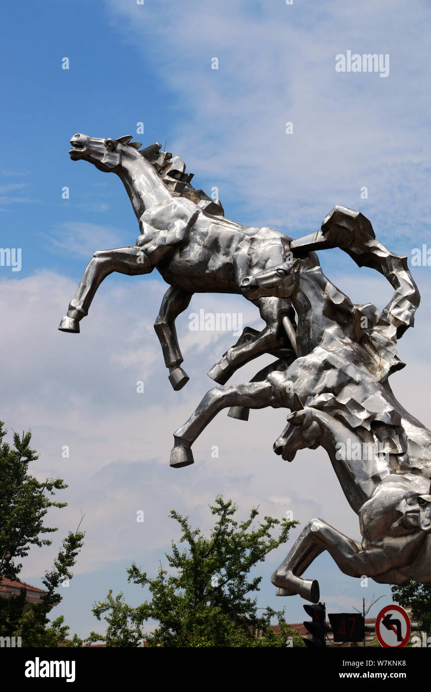 An artwork of "horses" piled up to form the shape of an arch door is ...