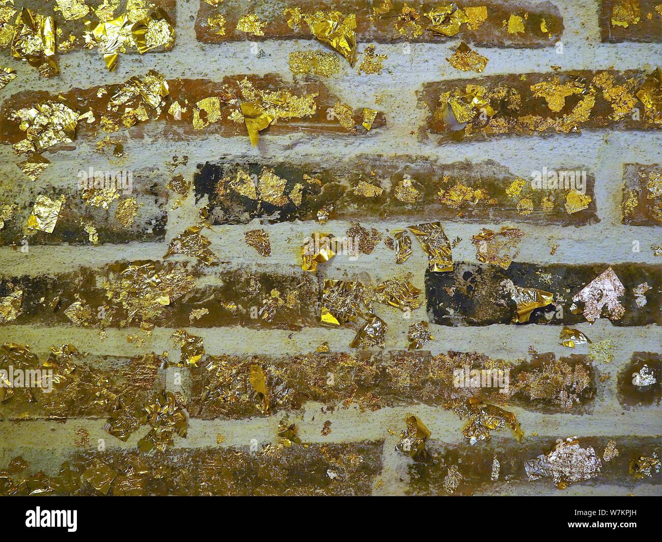 Gold leaf on brick wall Stock Photo - Alamy