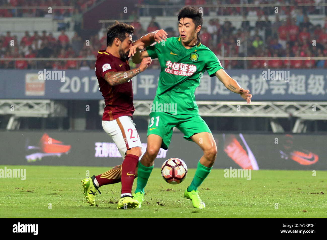 Argentine football player Ezequiel Lavezzi, left, of Hebei China ...
