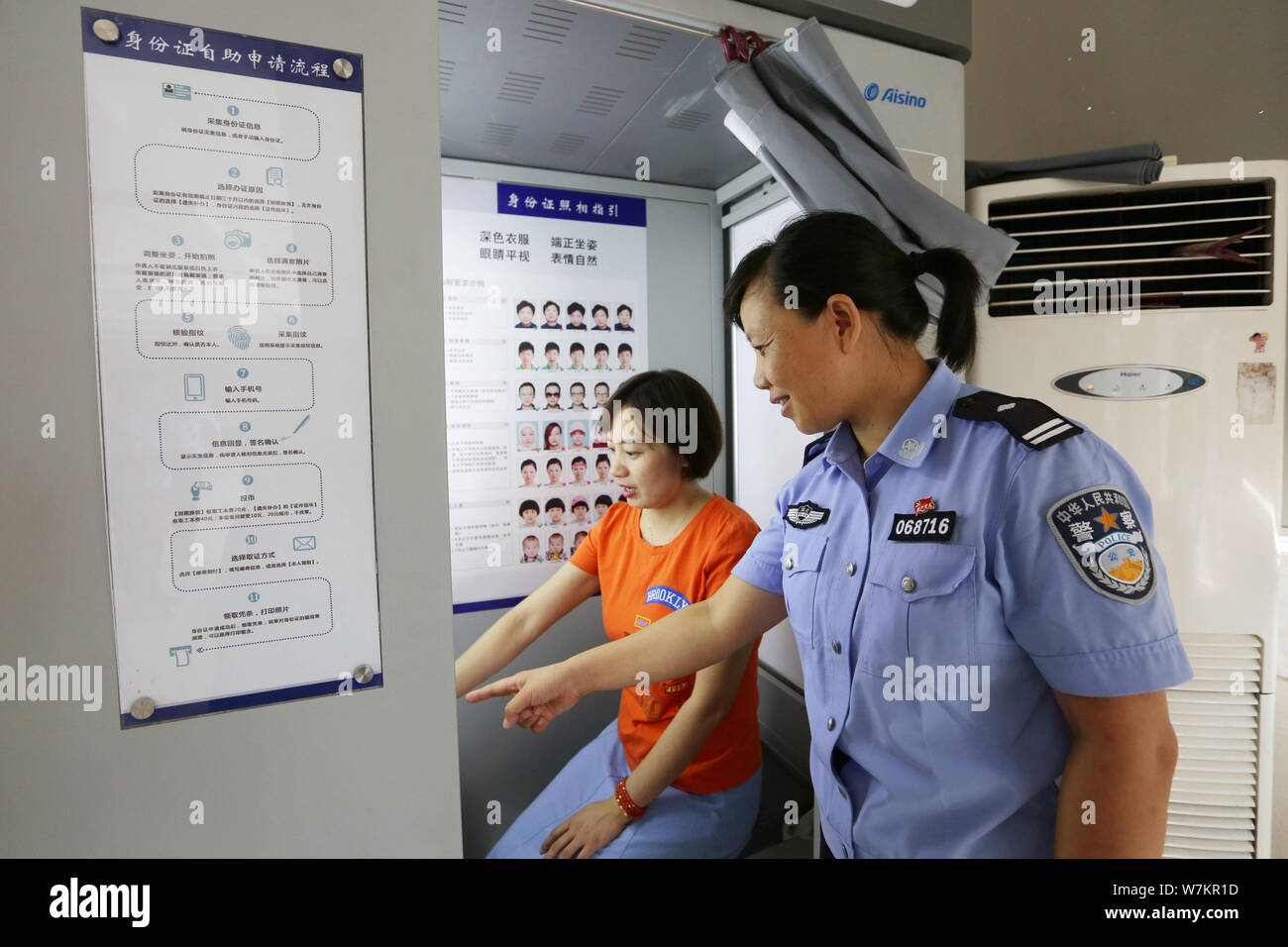A police officer instructs a local resident to apply for a new ID card ...