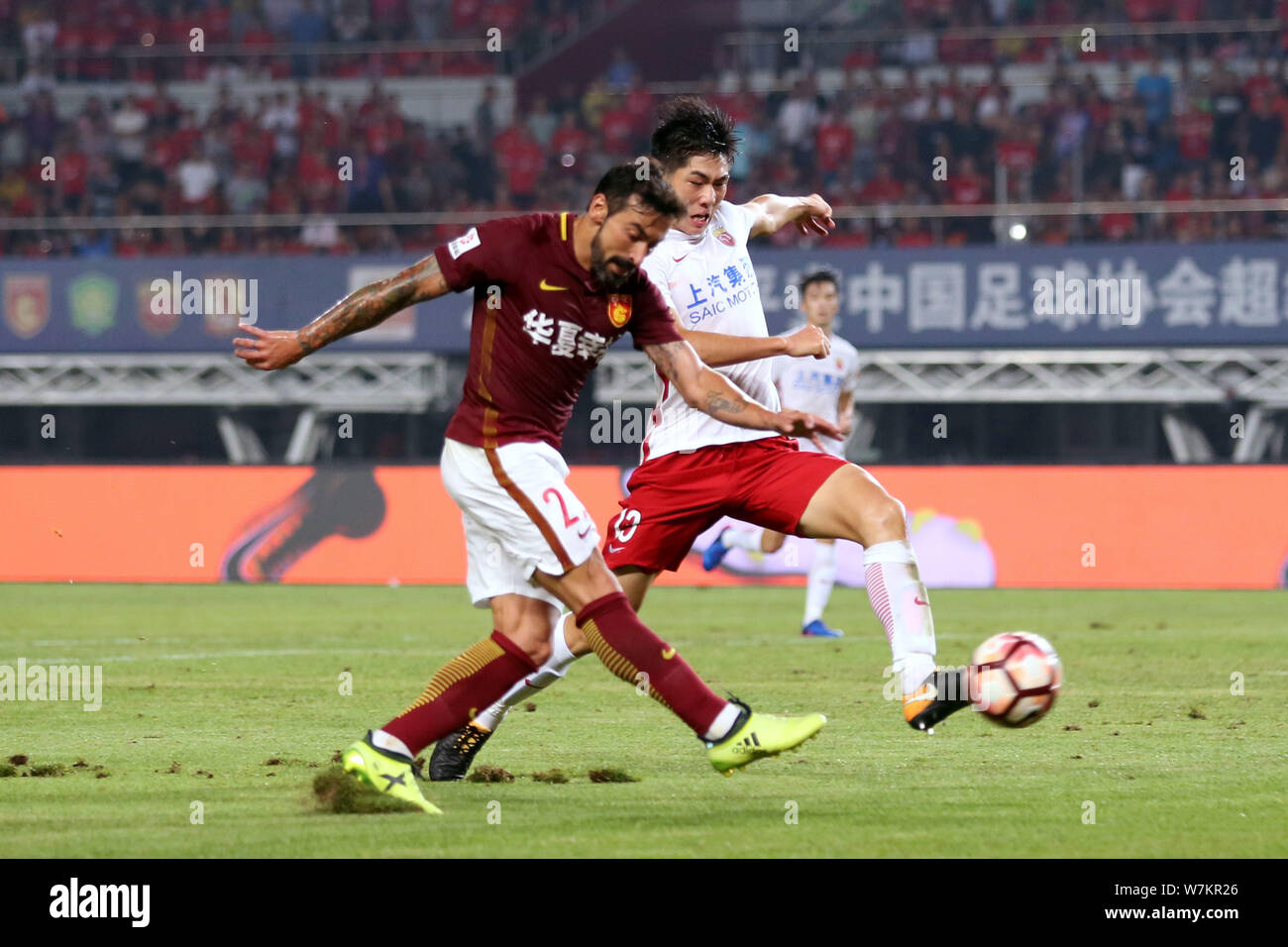 Argentine football player Ezequiel Lavezzi, left, of Hebei China ...