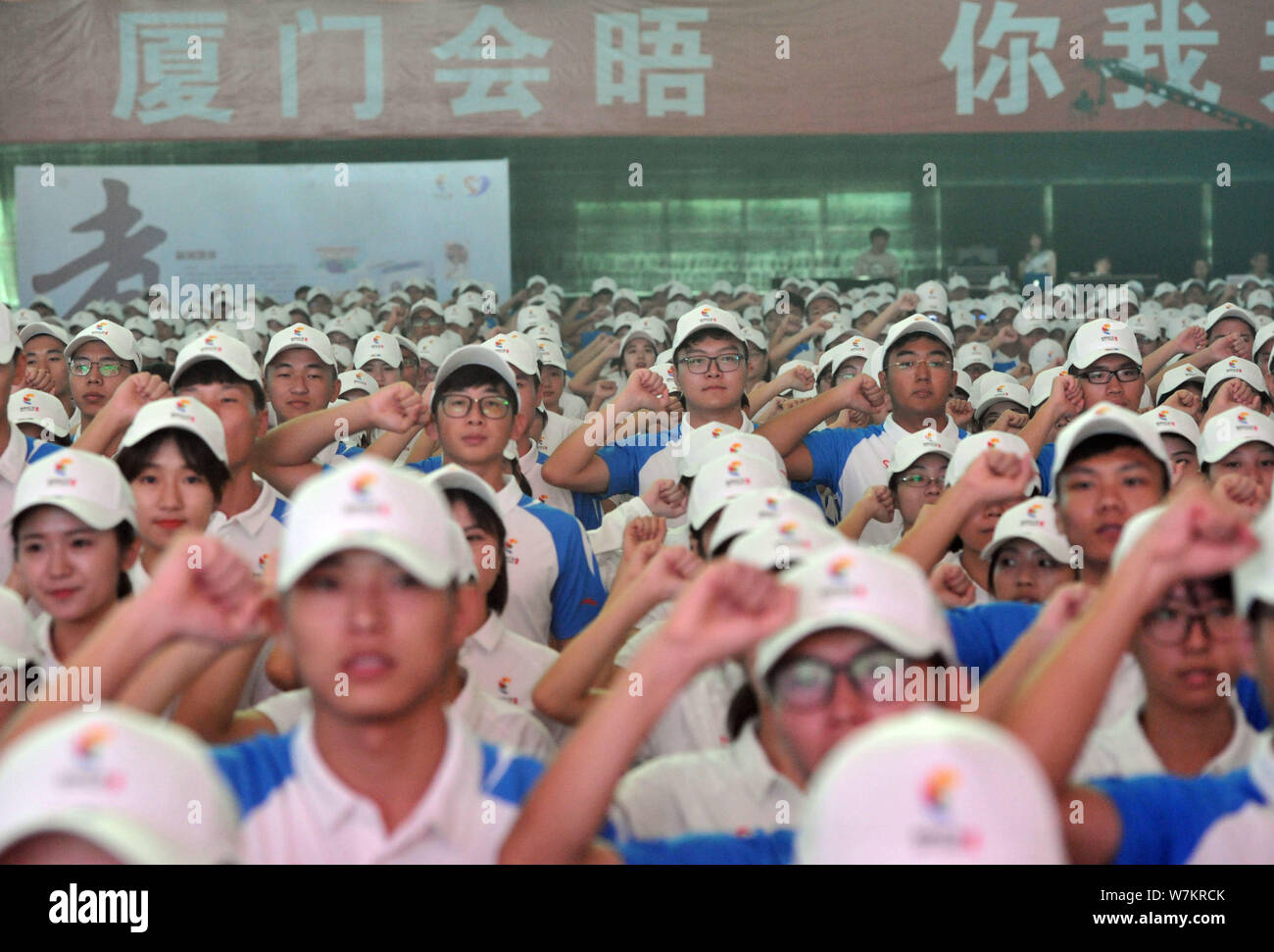 Chinese volunteers dressed in uniforms for the Ninth BRICS Summit swear ...