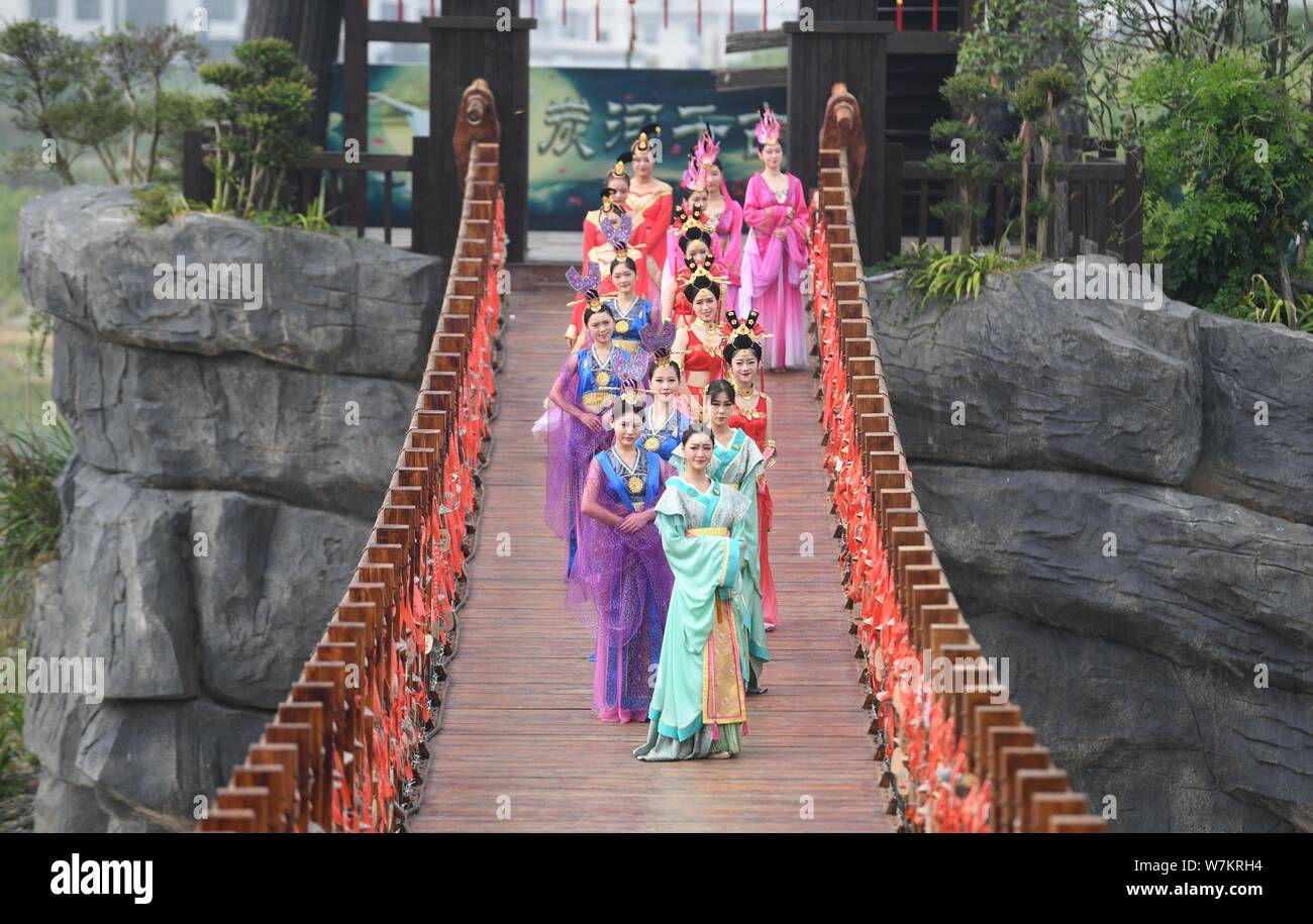 Chinese young people dressed in traditional costumes are seen as they ...