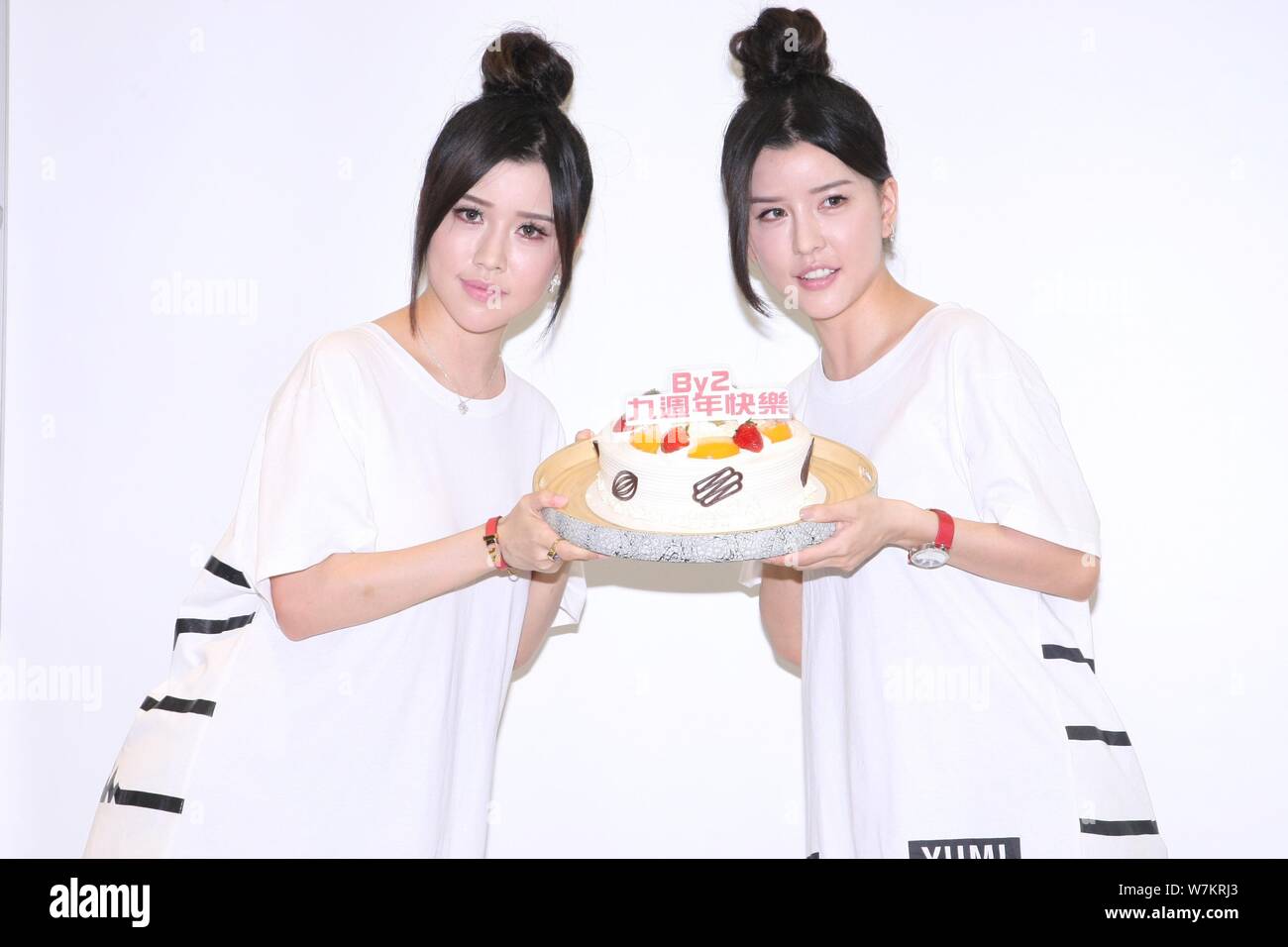 The twin sisters Miko Bai and Yumi Bai of Singaporean duo BY2 attend a ...