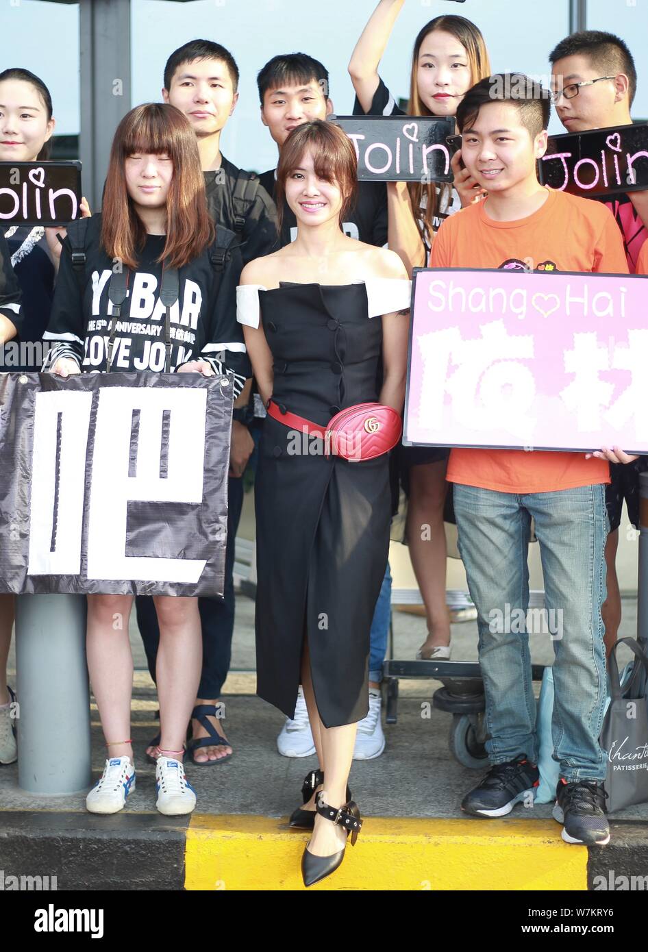Taiwanese singer Jolin Tsai, center, poses with fans as she arrives at the Shanghai Hongqiao ...