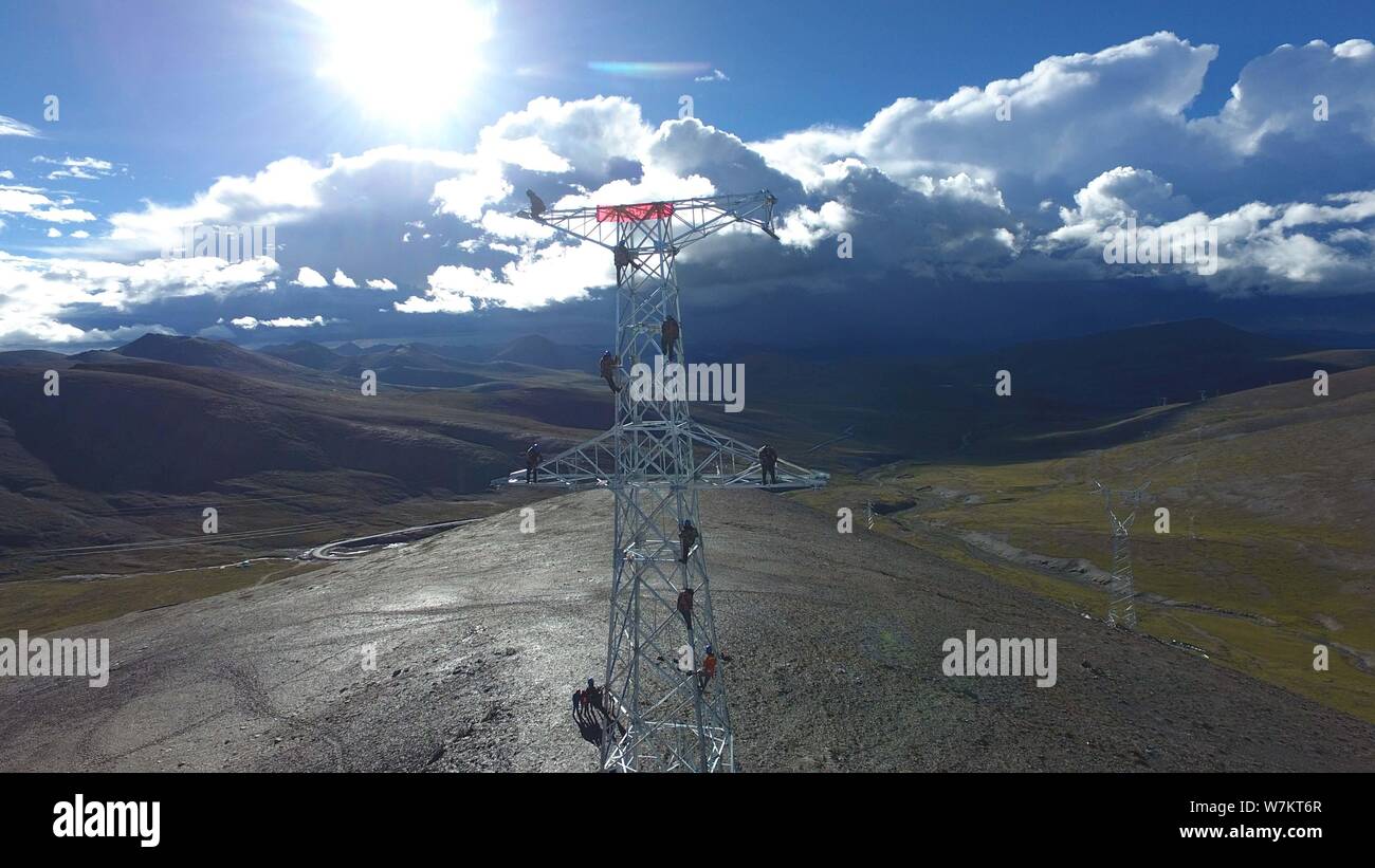 Electricity workers are assembling the highest power transmission tower in the world with a ...