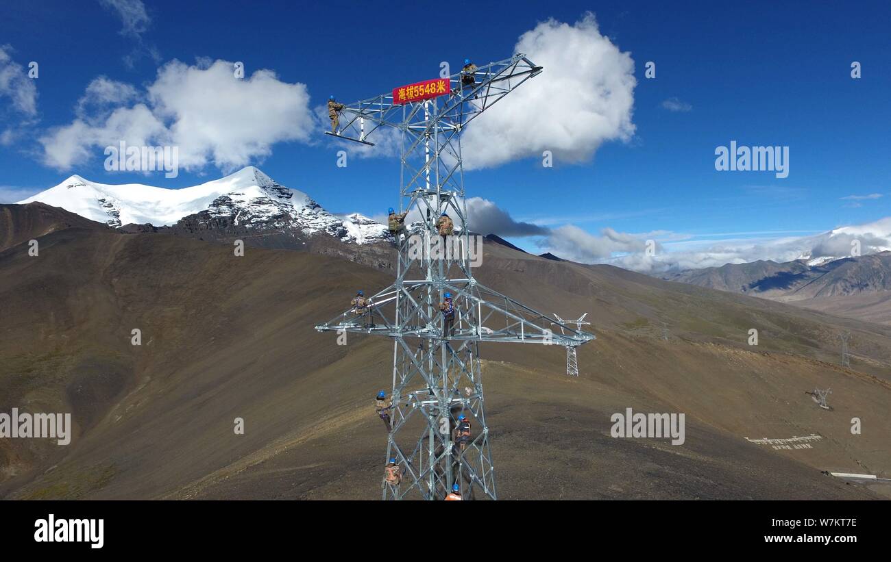 Electricity workers are assembling the highest power transmission tower in the world with a ...