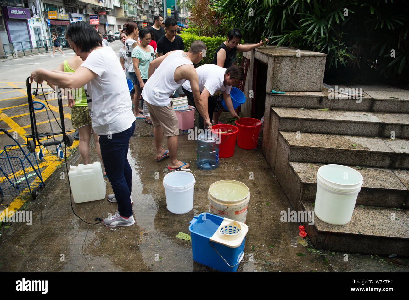 Local residents queue up to fetch water from a water point because of ...