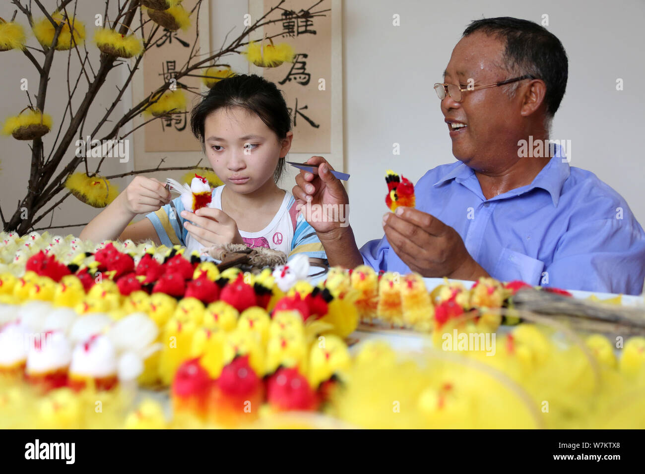 Chinese craftsman Cui Yongxin makes velvet roosters with his daughter ...