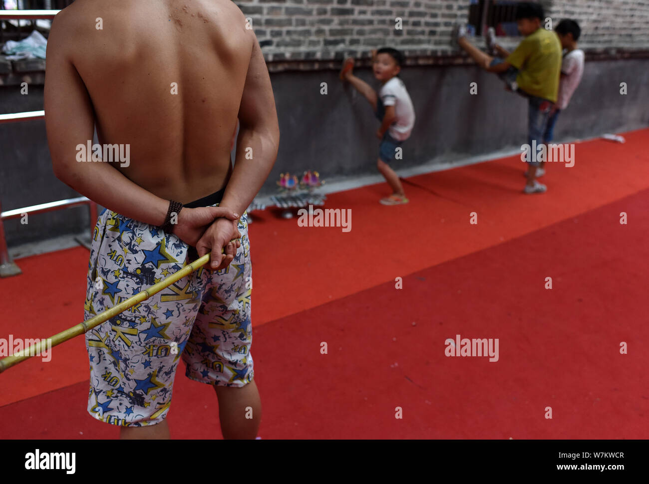 --FILE--An acrobatic artist is seen with a stick, a long piece of wood ...