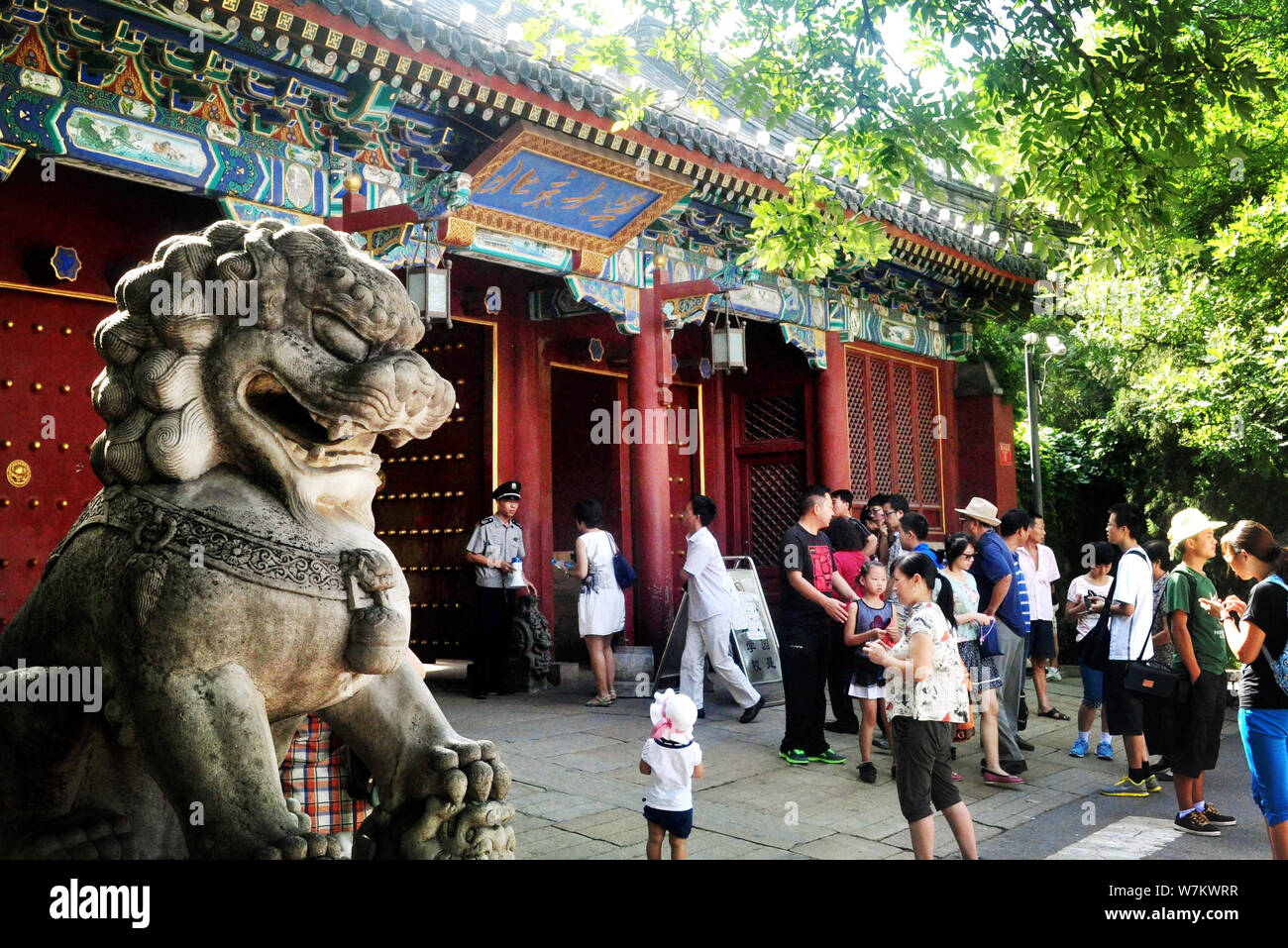 --FILE--Visitors take photos in front of the main gate of Peking ...