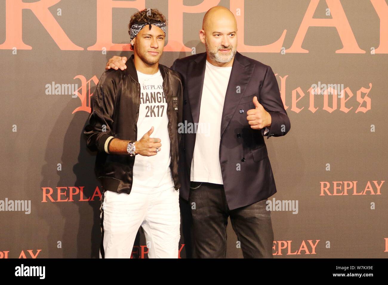 Brazilian football star Neymar, left, or Neymar Jr., poses as he ...