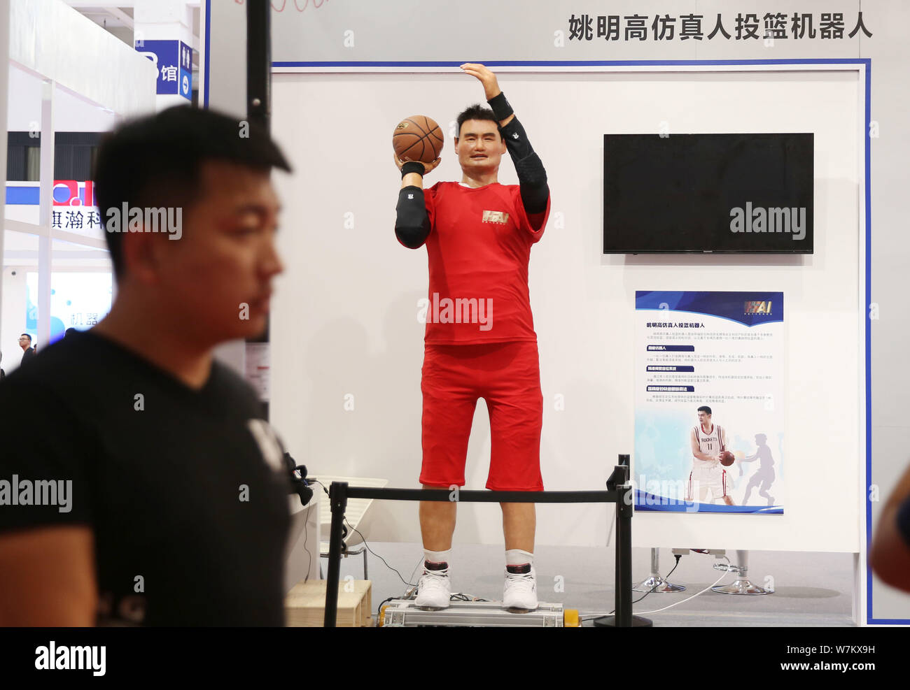 A life-size robot featuring Chinese basketball star Yao Ming shoot ...