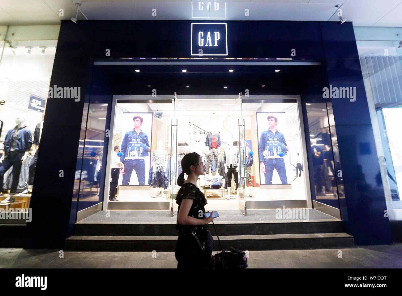 A pedestrian walks past the China's largest Gap flagship store on the ...