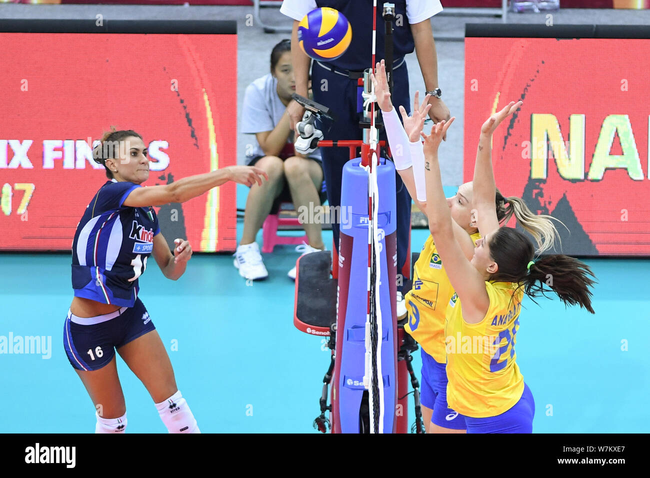 Lucia Bosetti of Italy, left, spikes against Brazil in their final ...