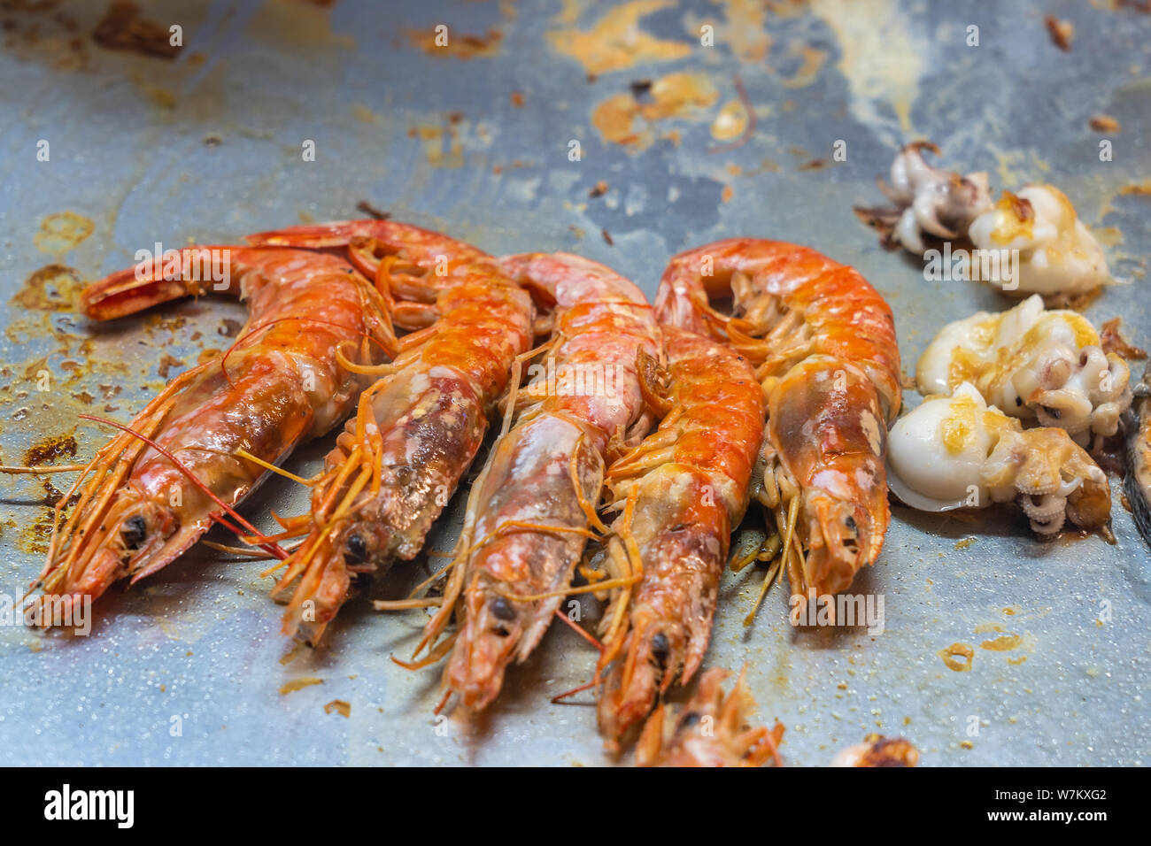 Delicious prawns and squids on grilling pan in buffet restaurant Stock ...