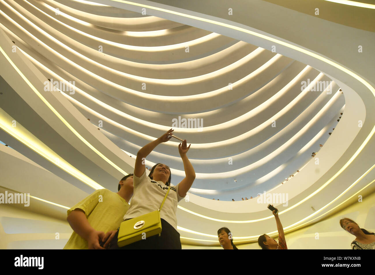 Local residents and tourists take photos of the Grand Theatre at the ...
