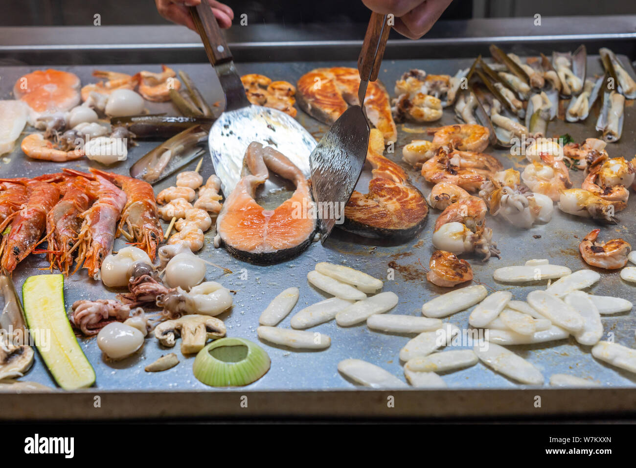 Chef cooking assortment of seafood on frying table in restaurant Stock ...