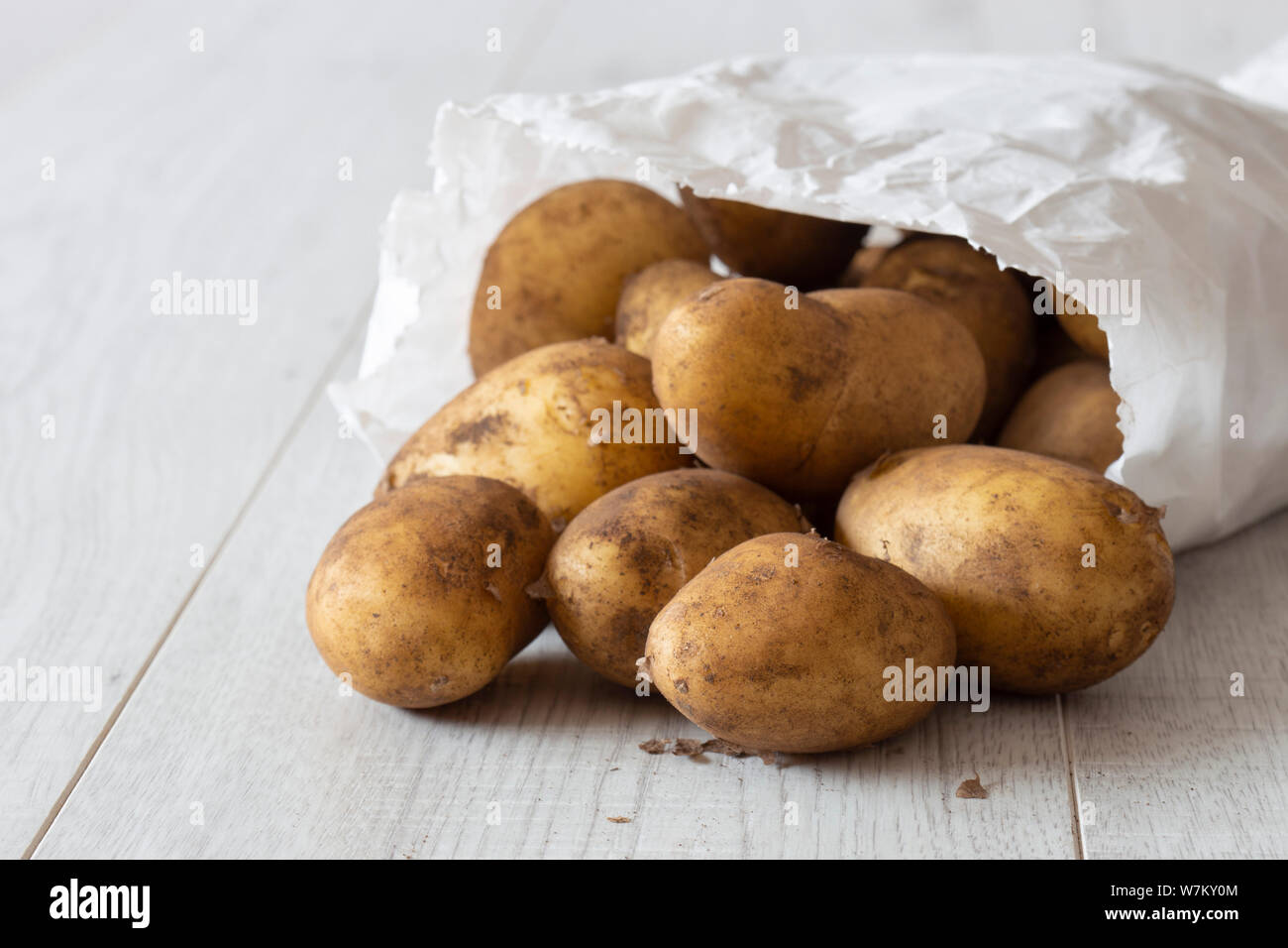 New potatoes in a white paper bag, environmentally friendly ...
