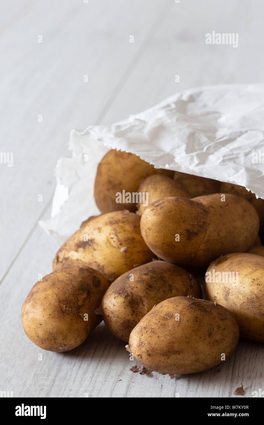 New potatoes in a white paper bag, environmentally friendly ...