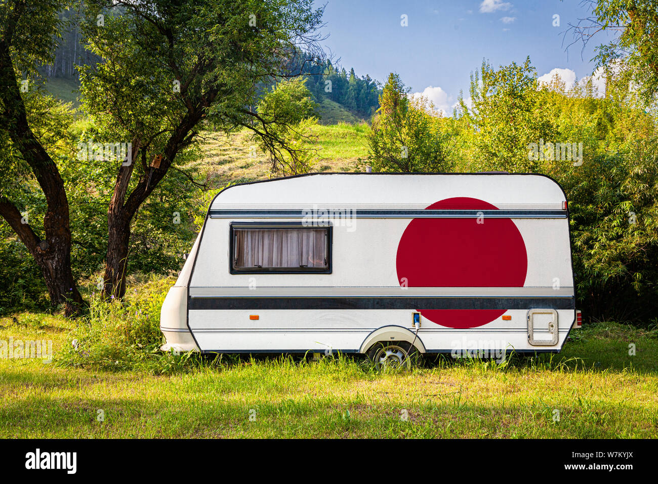 A car trailer, a motor home, painted in the national flag of Japan ...
