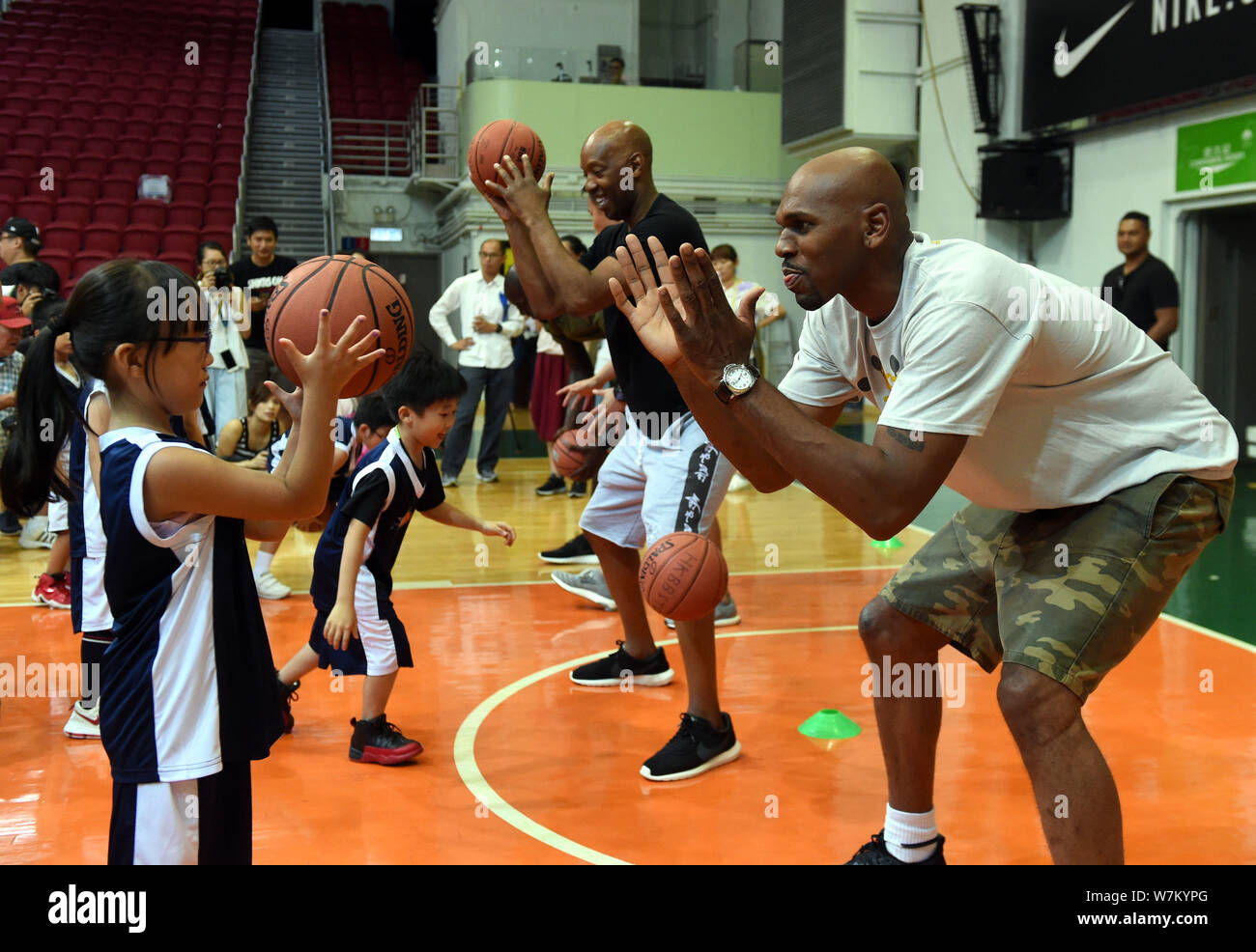 NBA star Jerry Stackhouse, right, instructs younger players during a ...
