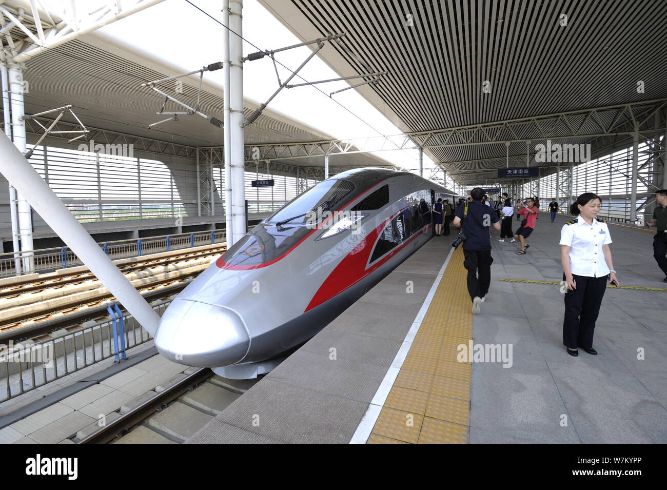 --FILE--Visitors take photos of a "Fuxing" high speed bullet train on ...