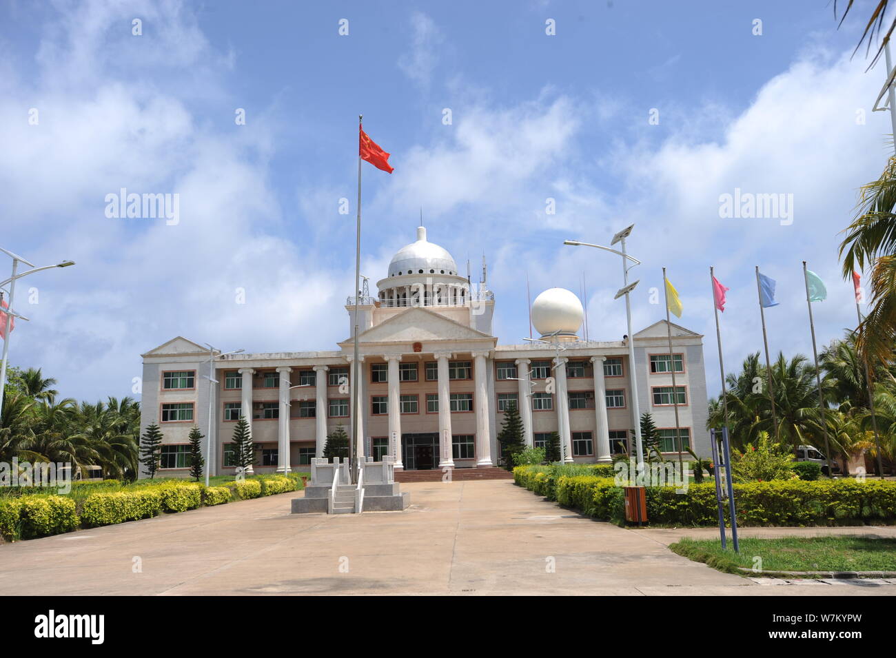 A Chinese national flag flutters in front of the government building of ...