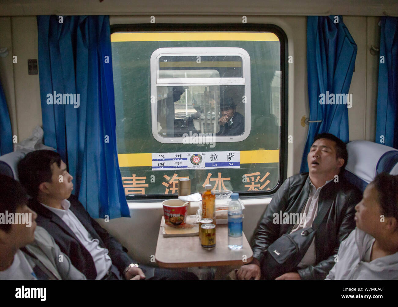 Passengers are pictured on a train running from Xining to Lhasa on the ...