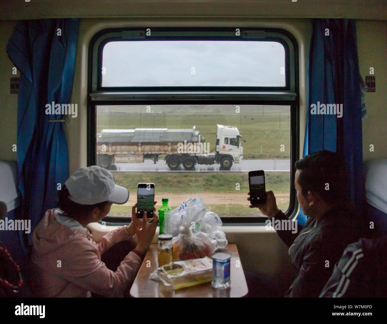 Passengers are pictured on a train running from Xining to Lhasa on the ...