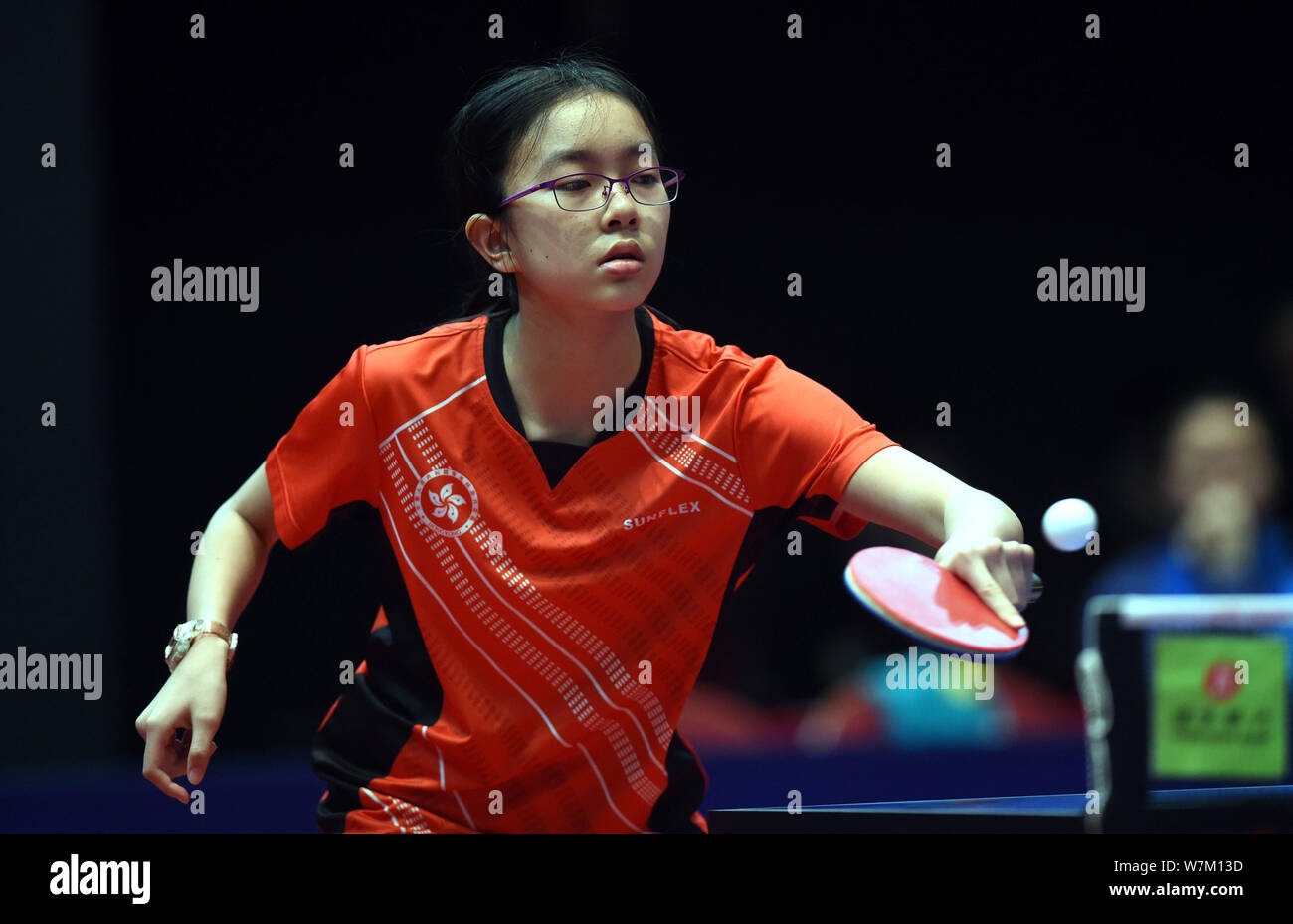 Ng Wing Lam of Hong Kong returns a shot as she and Lee Ka Yee compete ...