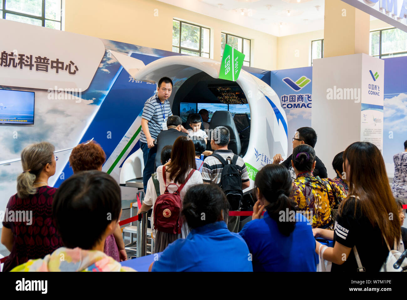 Visitors queue up to try out a flight simulator of China's first large ...